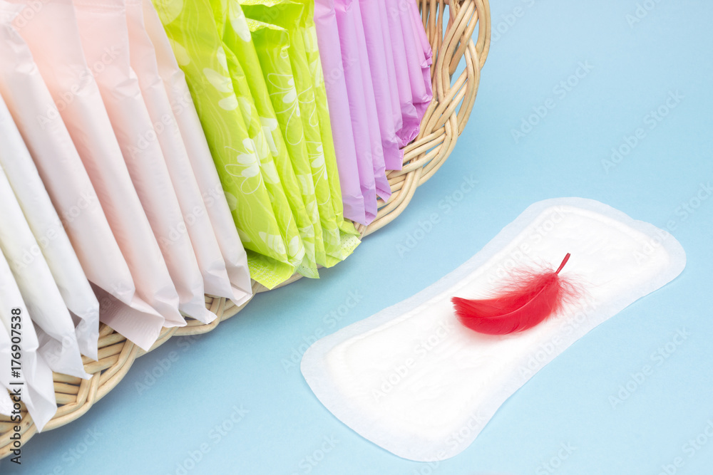 Feminine hygiene products, menstrual sanitary pads in the basket. First ...