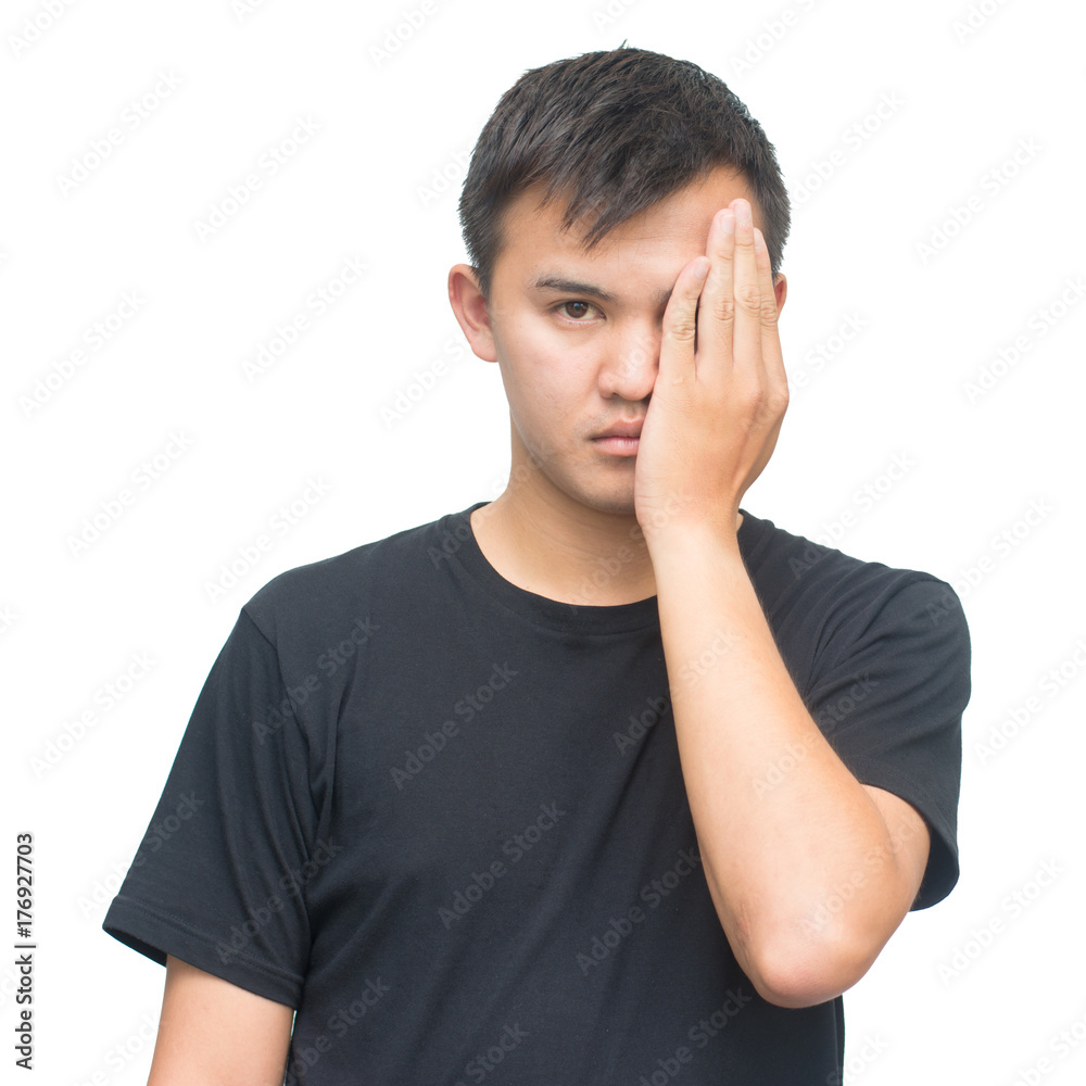 young man closes his one eye with his hand isolated on white background ...