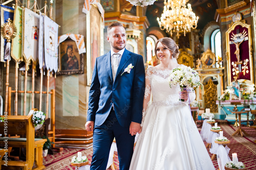 Amazing couple standing in the church after their wedding ceremony ...