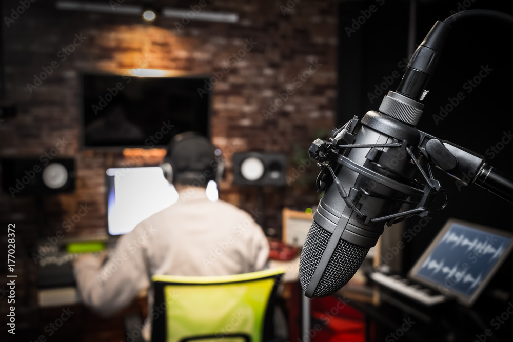 condenser microphone on back of asian male sound engineer working in ...