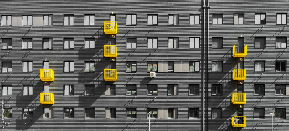 Exterior of gray residential building with yellow balcony Stock Photo ...