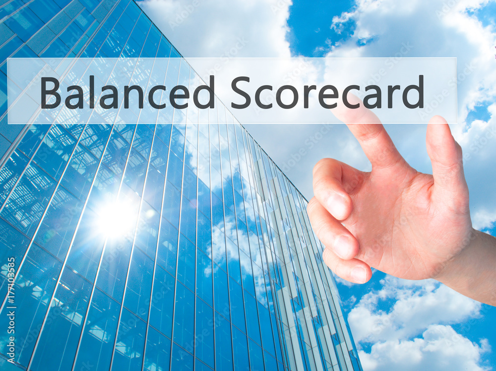 Balanced Scorecard - Hand pressing a button on blurred background ...