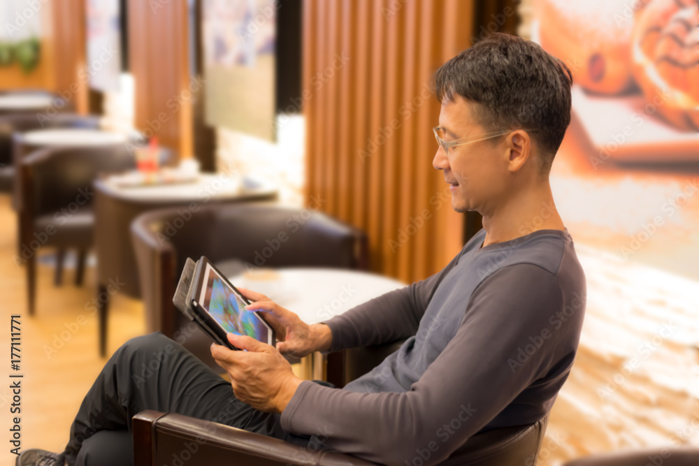 Middle aged generation and digital technology,blurred for background.De ...