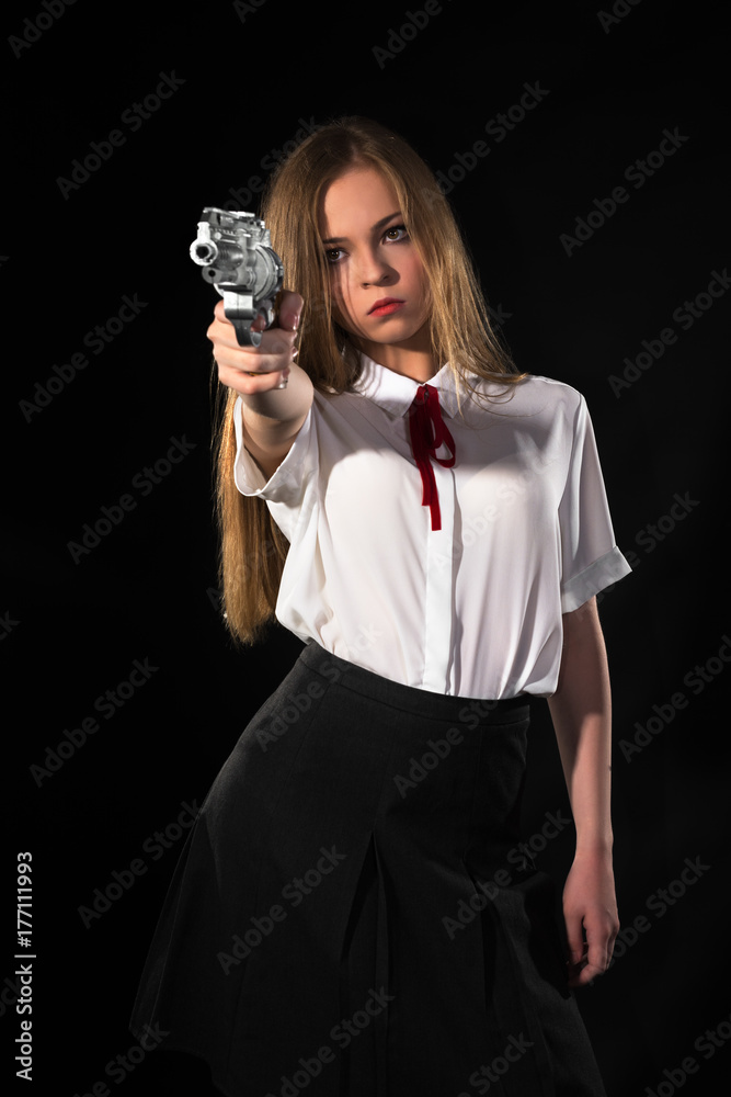 Anime cosplay, a beautiful young and dangerous girl with a gun in her ...