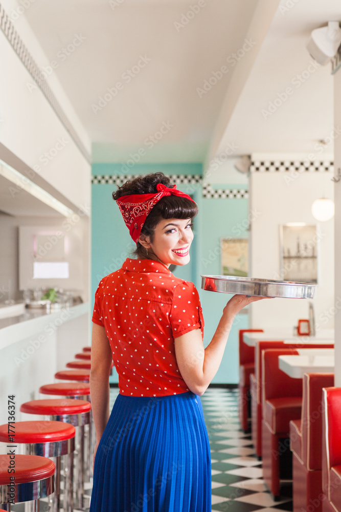 Handsome rockabilly pun up waitress serving at vintage cafe. Stock ...