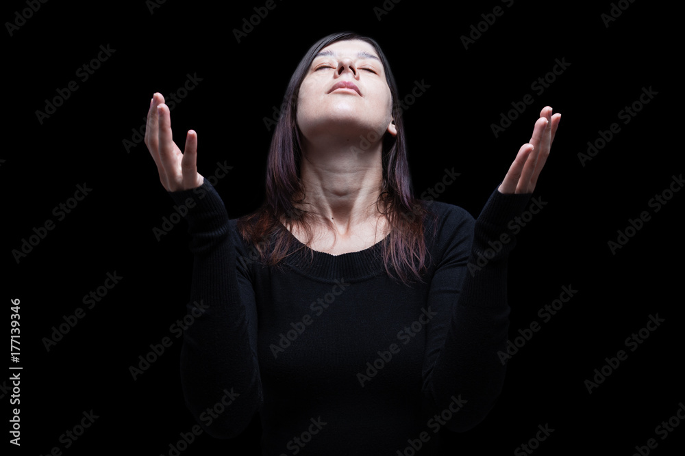 Mourning woman praying, with arms outstretched in worship to god, head ...