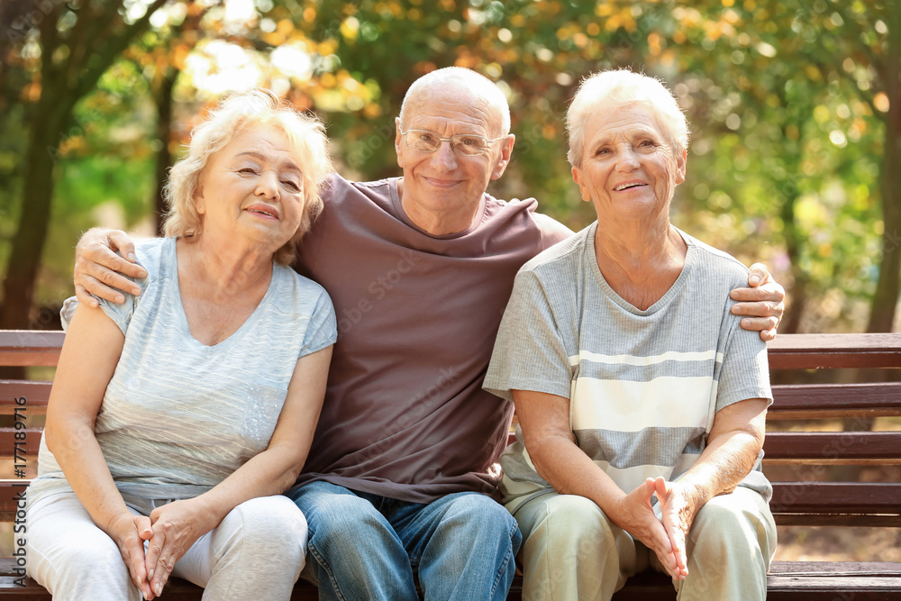 Elderly people sitting on bench in park Stock Photo | Adobe Stock
