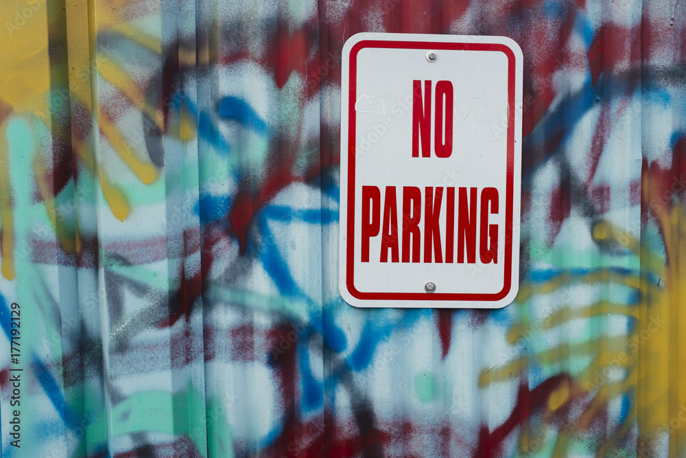 No Parking sign on graffiti covered wall Stock Photo | Adobe Stock