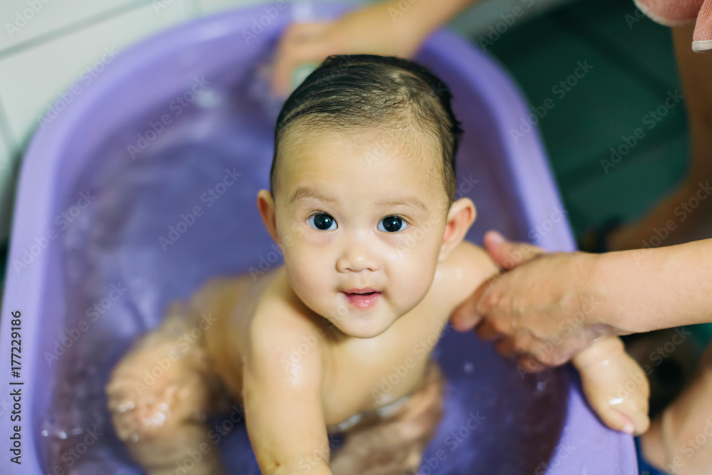 7 months cute baby bathing with her mother in the bath room. Stock ...