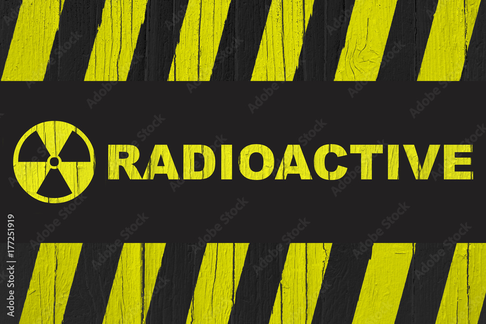 Radioactive warning sign with yellow and black stripes painted over ...
