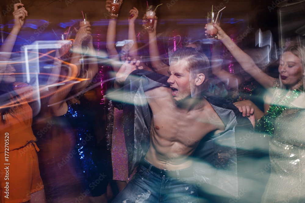 Sexy macho on dance floor. Joyful New Year in night club, positive ...