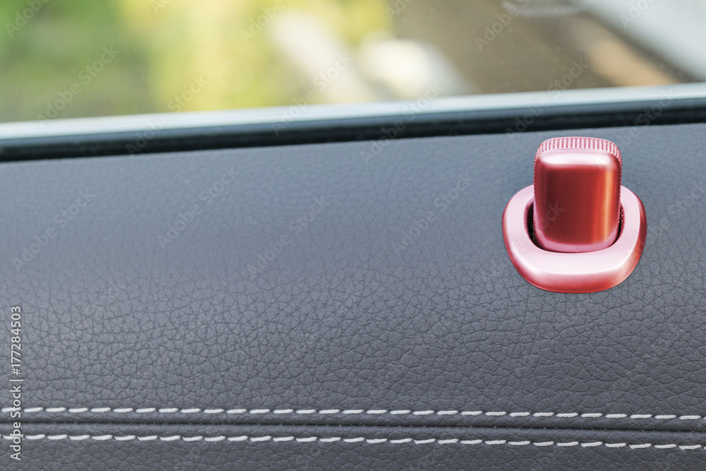 Door handle with red lock control buttons of a luxury passenger car ...