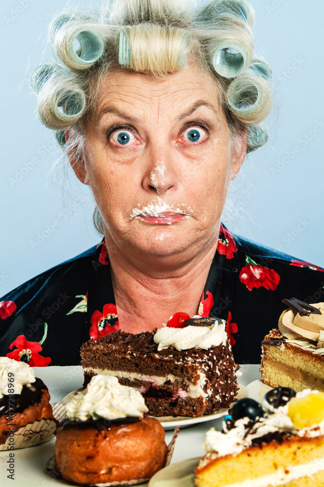 Senior Woman with Rollers in her Hair, indulging in her Guilty pleasure ...