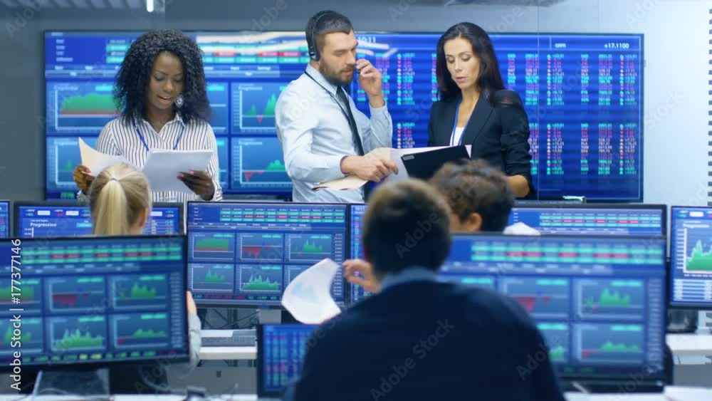 Multi-Ethnic Team of Traders is Busy Working at the Stock Exchange ...