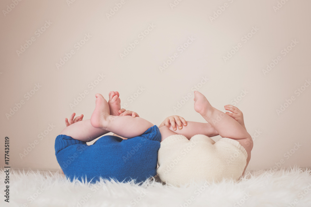 Bums and feet of twin babies from below Stock Photo | Adobe Stock