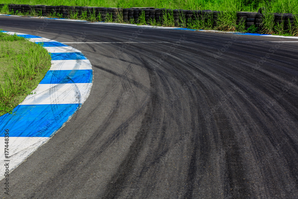 Motor racing track. Turning asphalt road with marking lines at ...