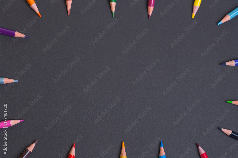 Vivid colored pencils are located around the perimeter of the sheet a ...