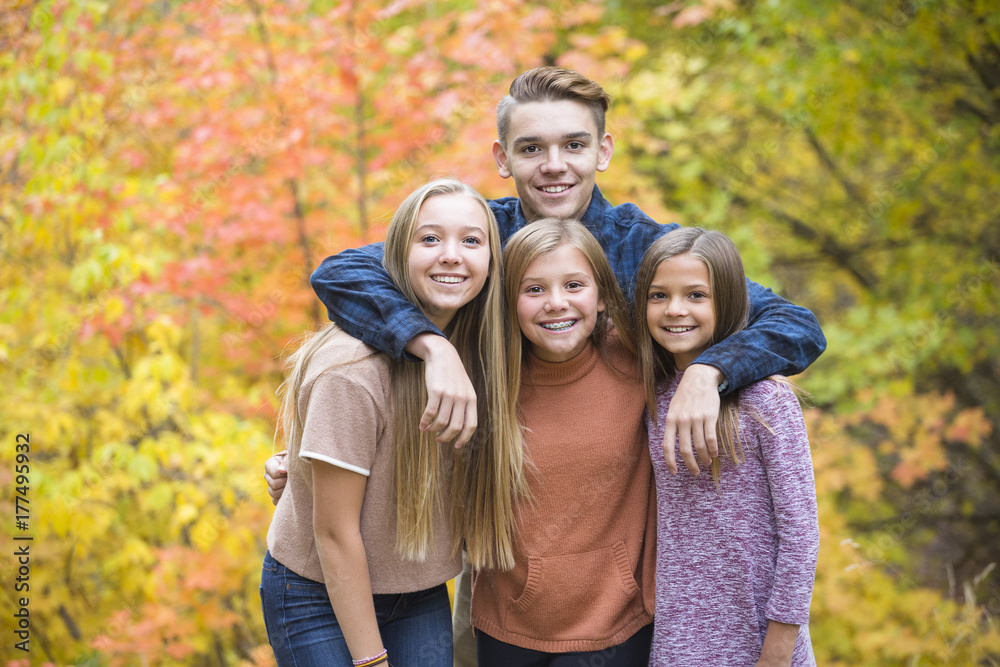 Beautiful Portrait of smiling happy teen kids outdoors. Four siblings ...