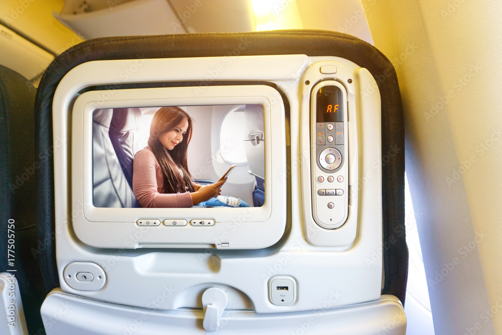 Passenger seat of plane with screen image beautiful asian woman use of ...