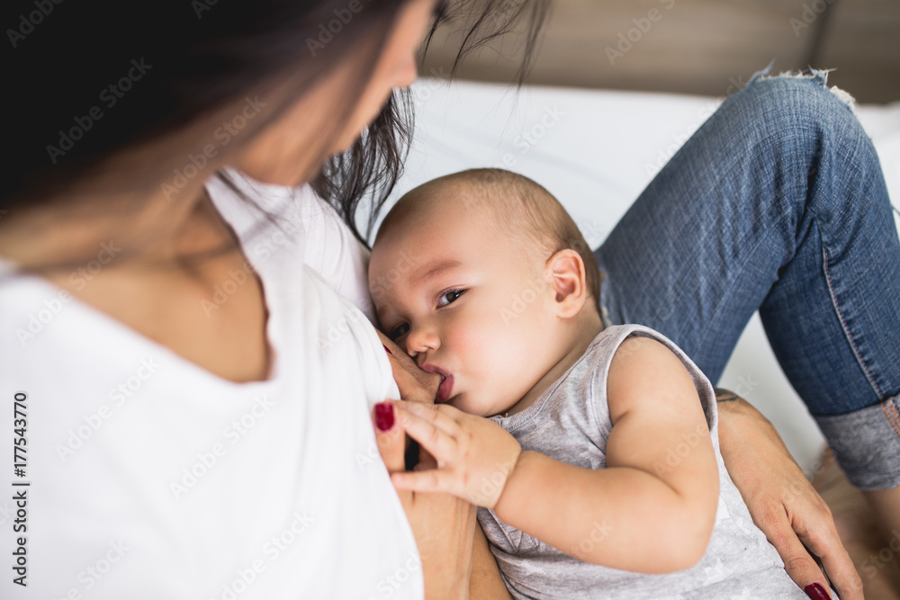 Beautiful mother brest feeding her cute little baby. Stock Photo ...