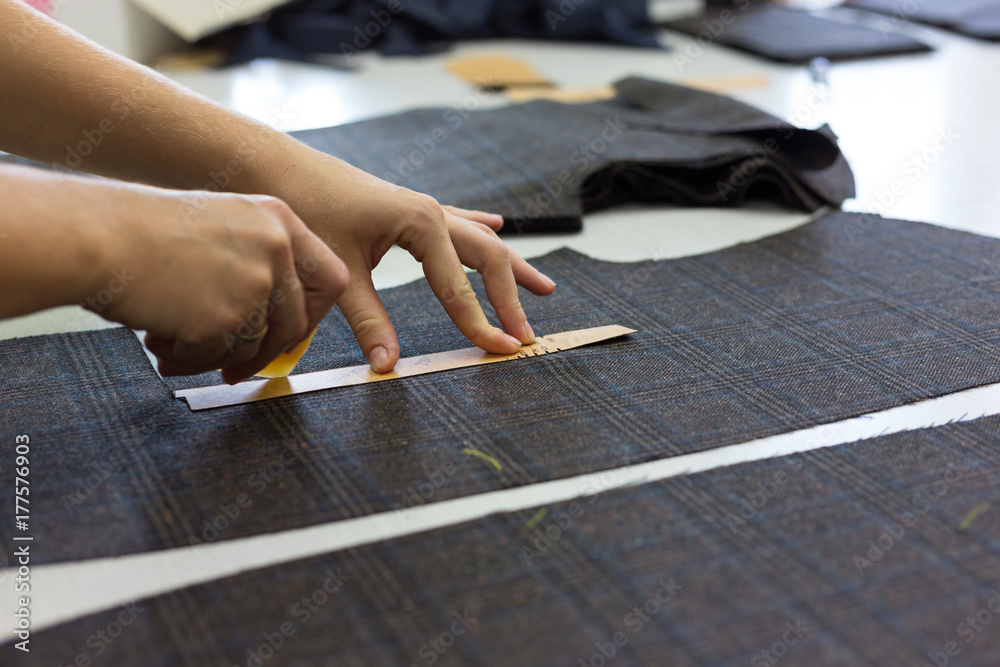Female hands matching checkered pattern, constructing a suit out of ...