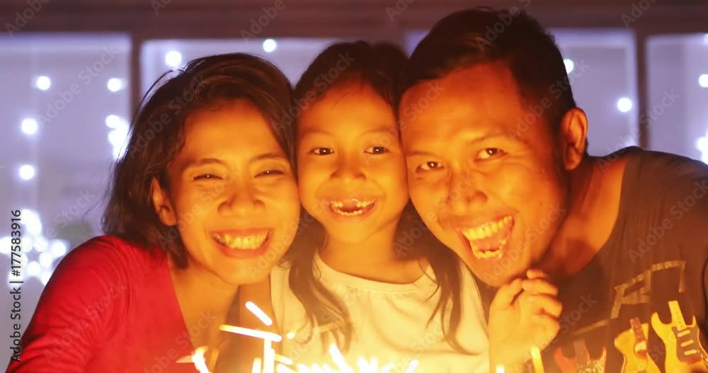 Two happy parents and their toothless daughter playing Christmas ...