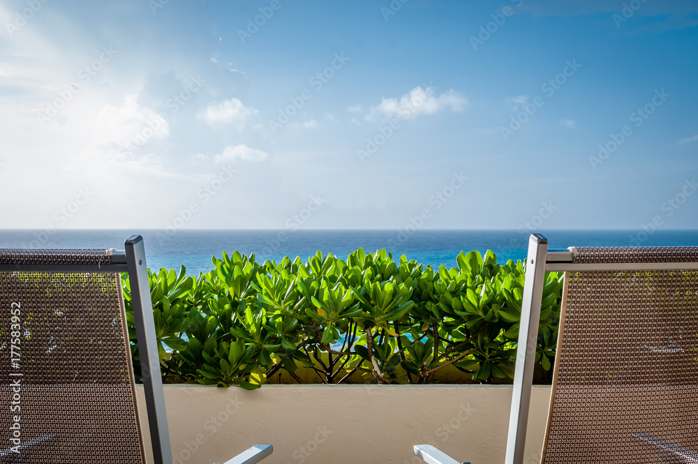 Balcony view of beach chairs looking out to ocean sea. Isolated mesh ...