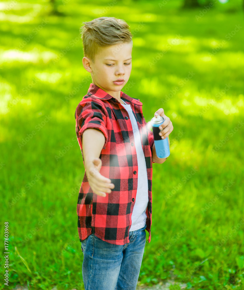 Boy spraying insect repellents on skin Stock-Foto | Adobe Stock