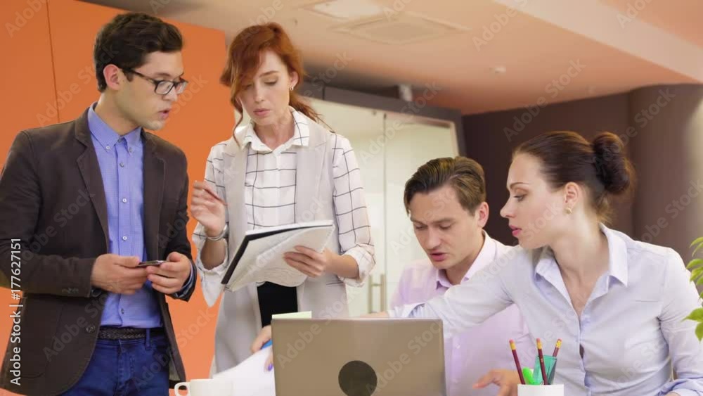 Active teamwork of young energetic colleagues, working and ...