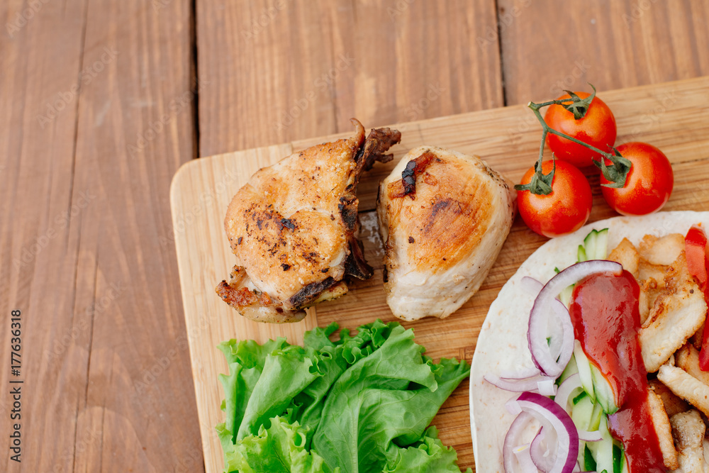 The process of preparing chiken shawarma. Ingredients sliced lie on the ...