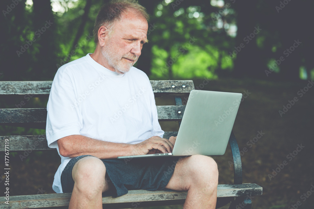 Closeup portrait, senior mature man in white shirt typing away ...