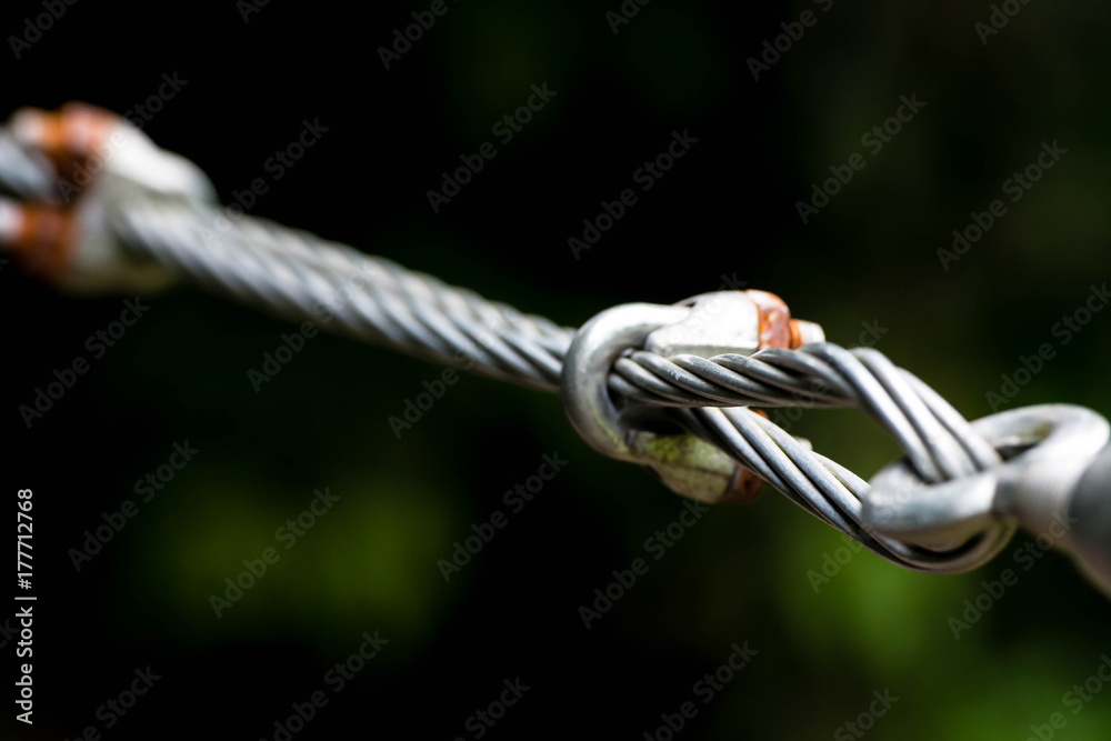 A close up of heavy duty steel wire cable connector. Coils of wire rope ...