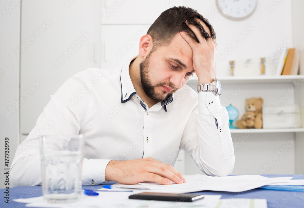 Man struggling to pay bills Stock Photo | Adobe Stock