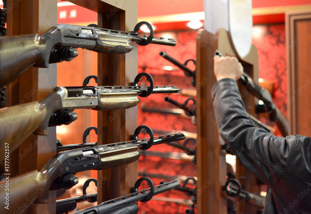 Submachine Gun on the wood wall close-up Stock Photo | Adobe Stock