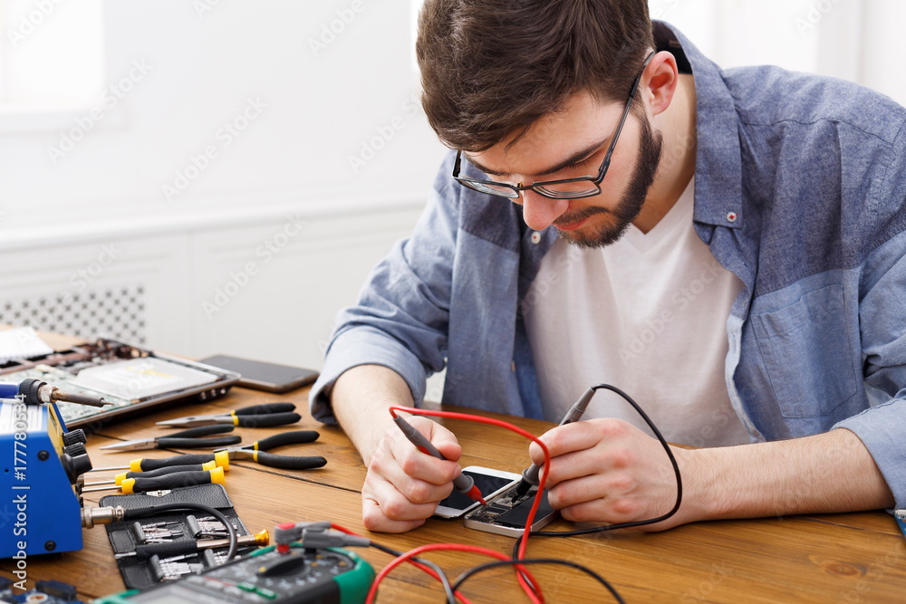 Repairing smartphone with multimeter Stock Photo | Adobe Stock