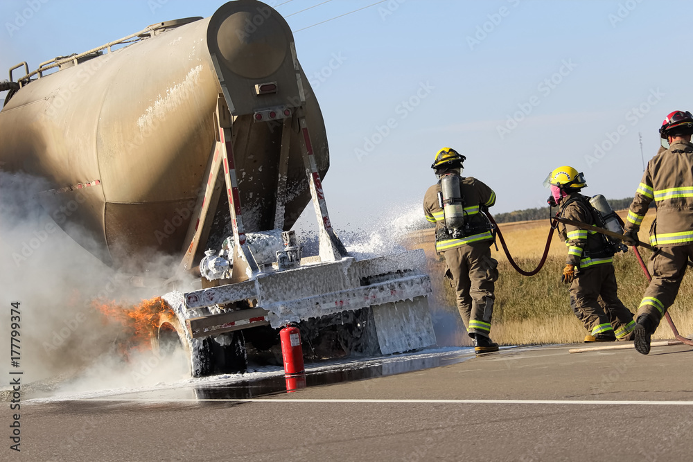 Three fireman rush to put out a brake fire on a semi-truck Stock Photo ...