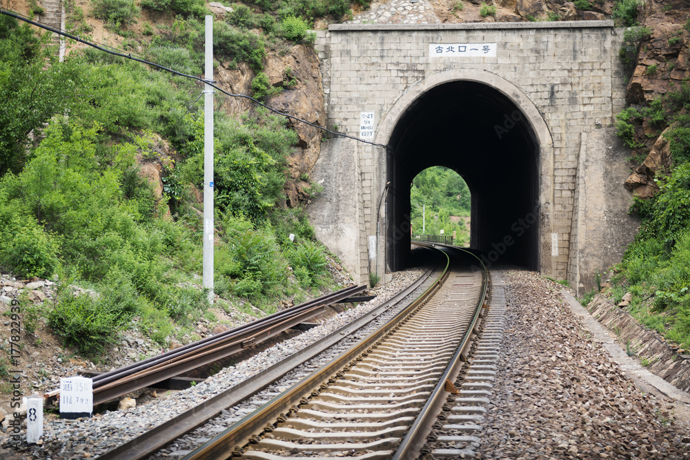 Cave in the mountain and railway for train Stock Photo | Adobe Stock