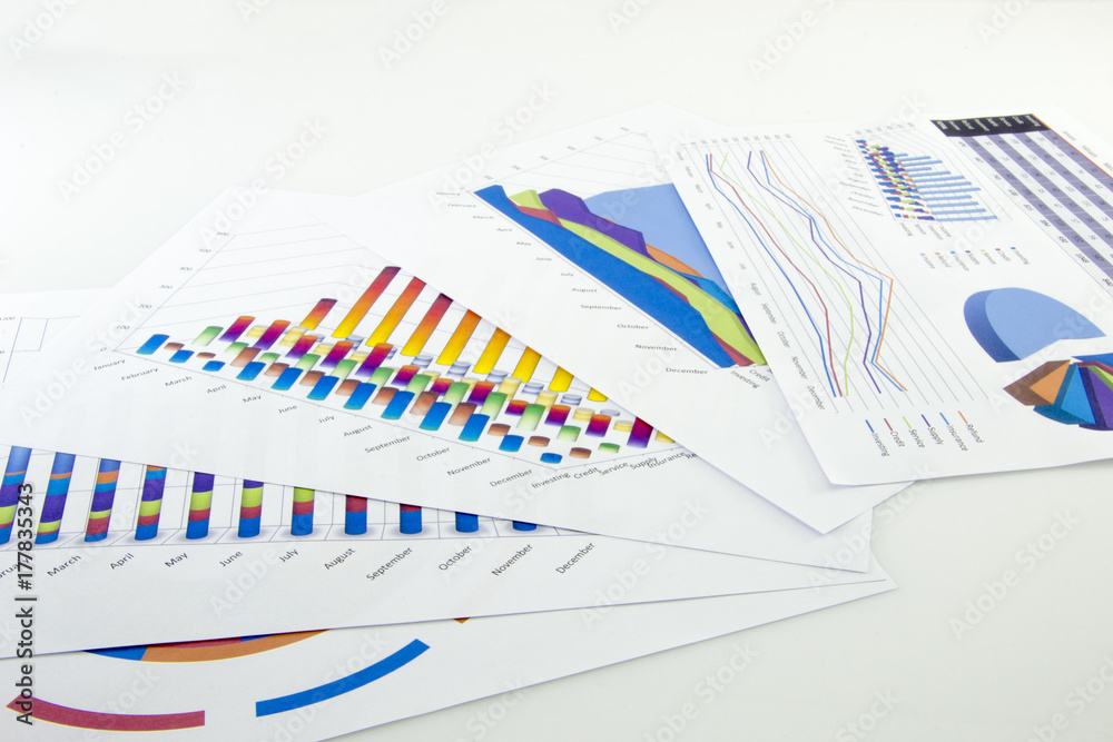 Preparing report. Blue graphs and charts. Business reports and pile of ...