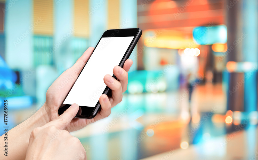 Hand click mobile phone with blur office corridor hall way background ...