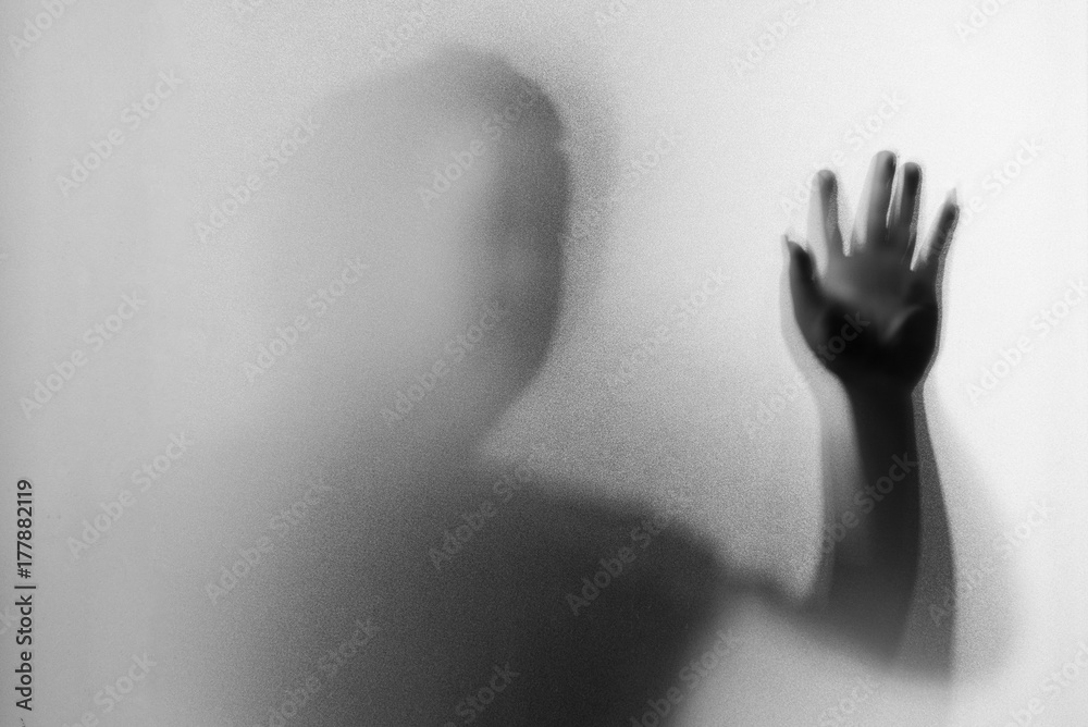 Shadow blur of horror man.Dangerous man behind the frosted glass ...
