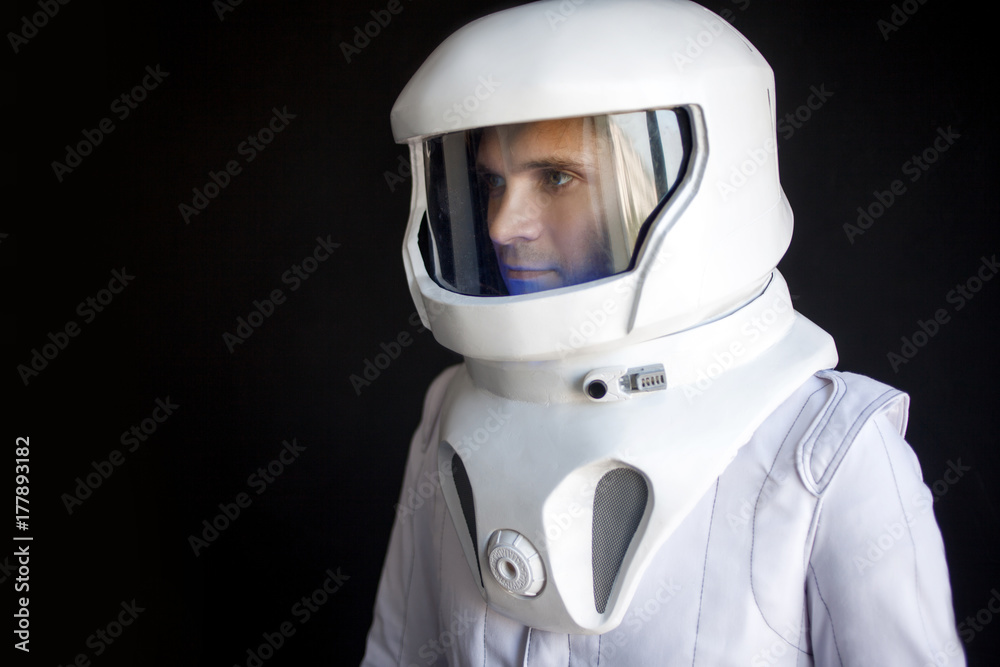 Astronaut in a helmet looks down. Fantastic space suit. Exploration of ...