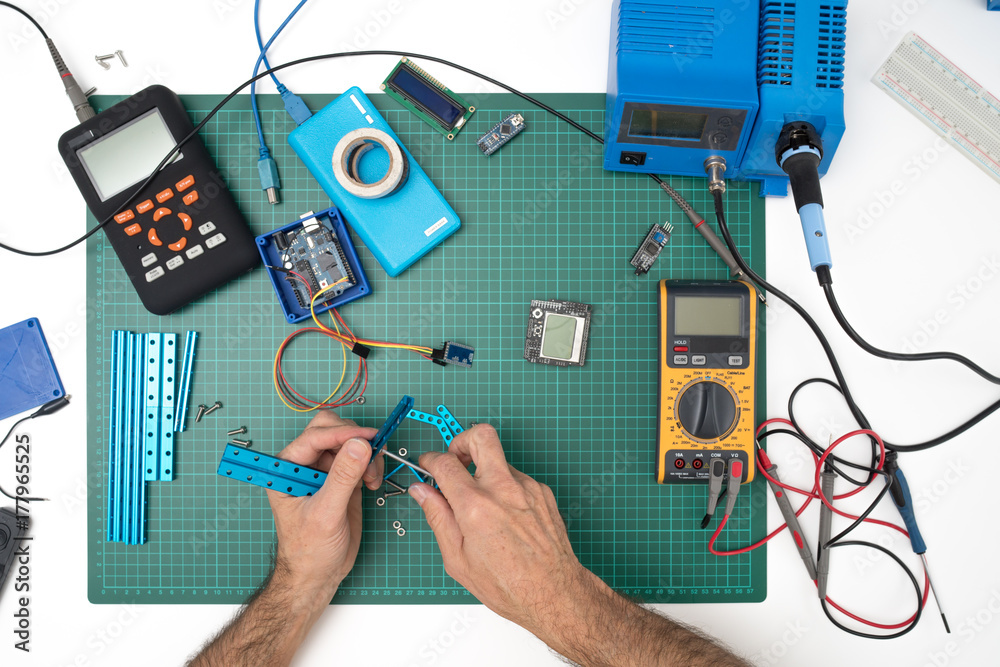 manual assembly of electronic mechanical device from a set of spare ...