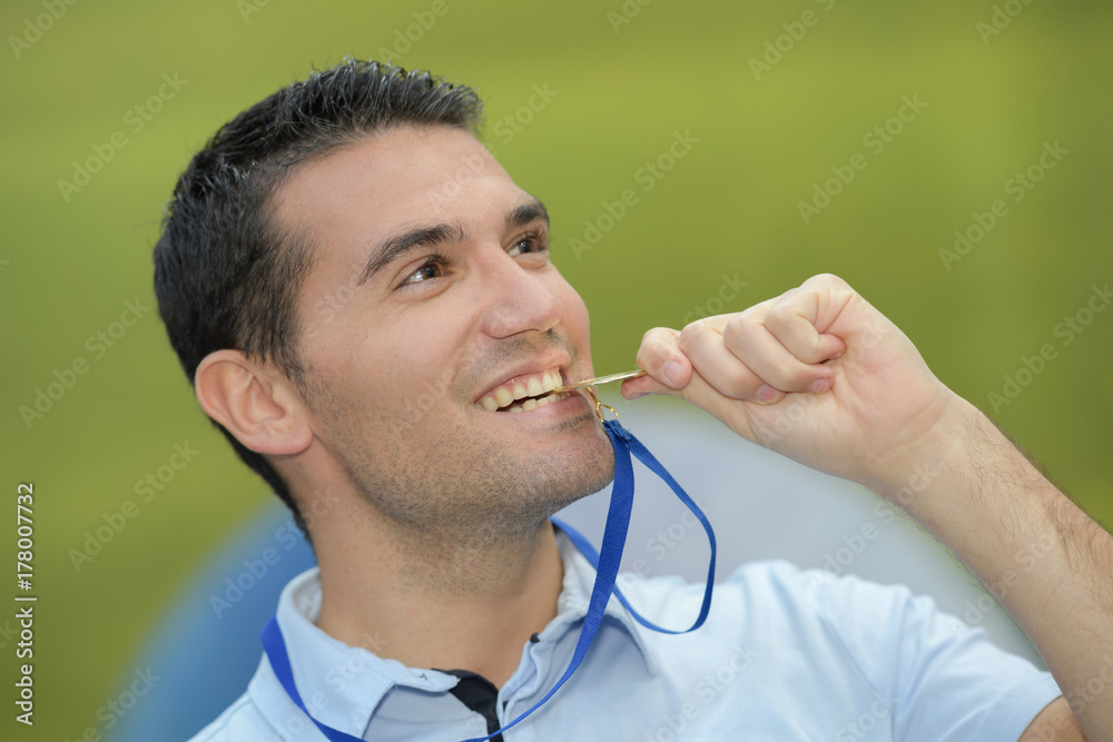 winner biting gold medal Stock Photo | Adobe Stock