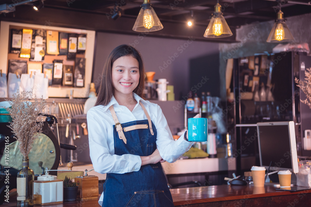 Beautiful asian barista holding coffee cup and smiles in her cafe Stock ...
