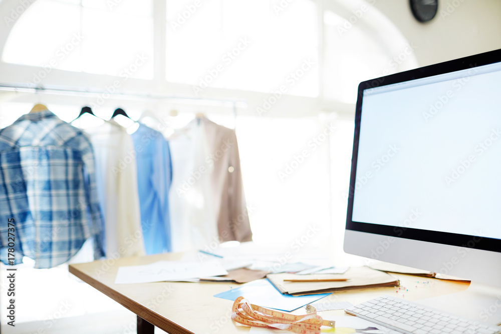 Workplace of fashion designer with computer monitor, measuring-tape ...