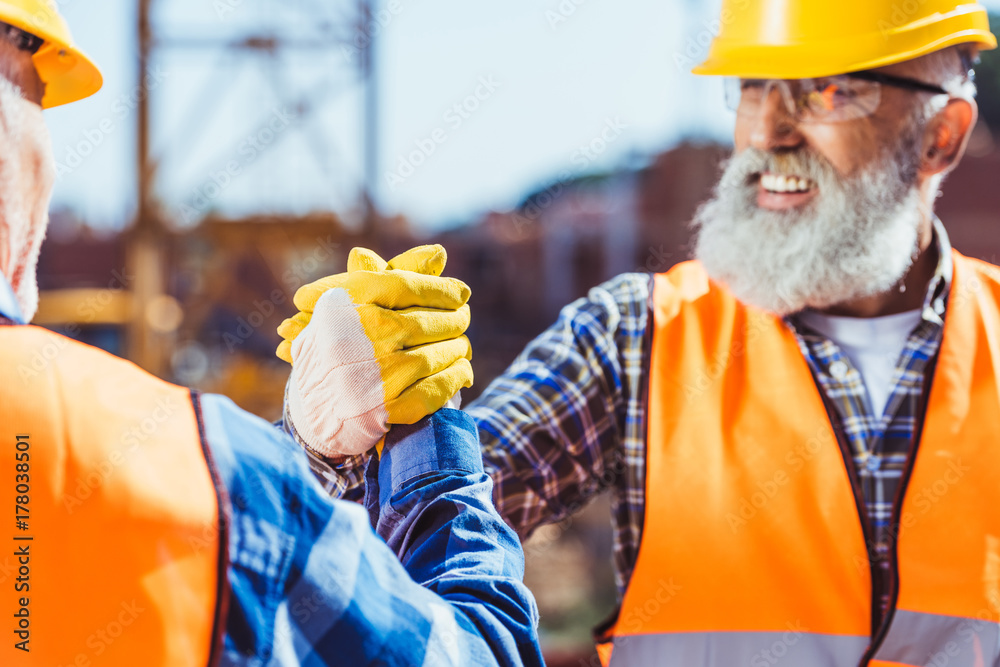 construction workers shaking hands Stock Photo | Adobe Stock
