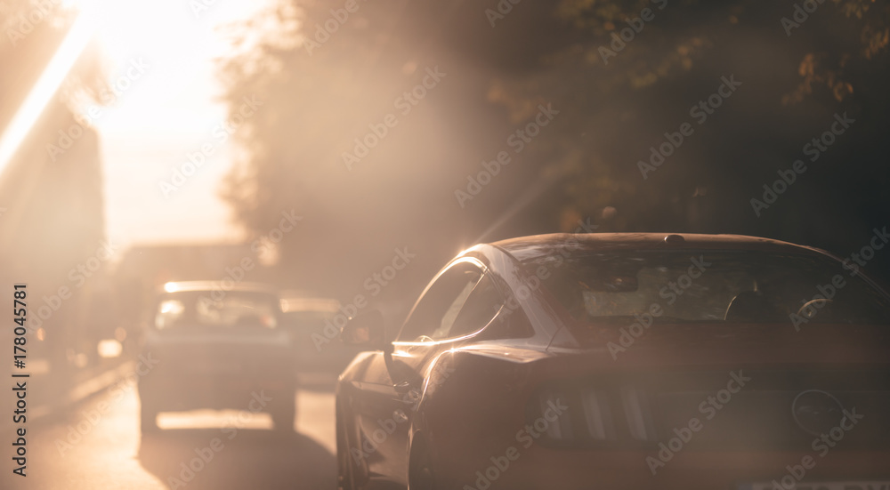 the red sports car is stopped at the traffic lights. the hand of the ...