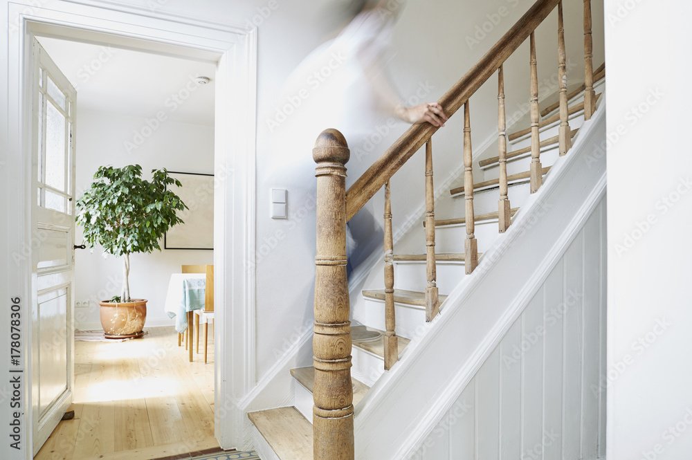 Man going upstairs on wooden stairs in an old country house Stock Photo ...