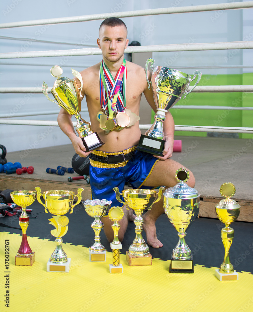 Young boxing champion posing with many medals around his neck and ...