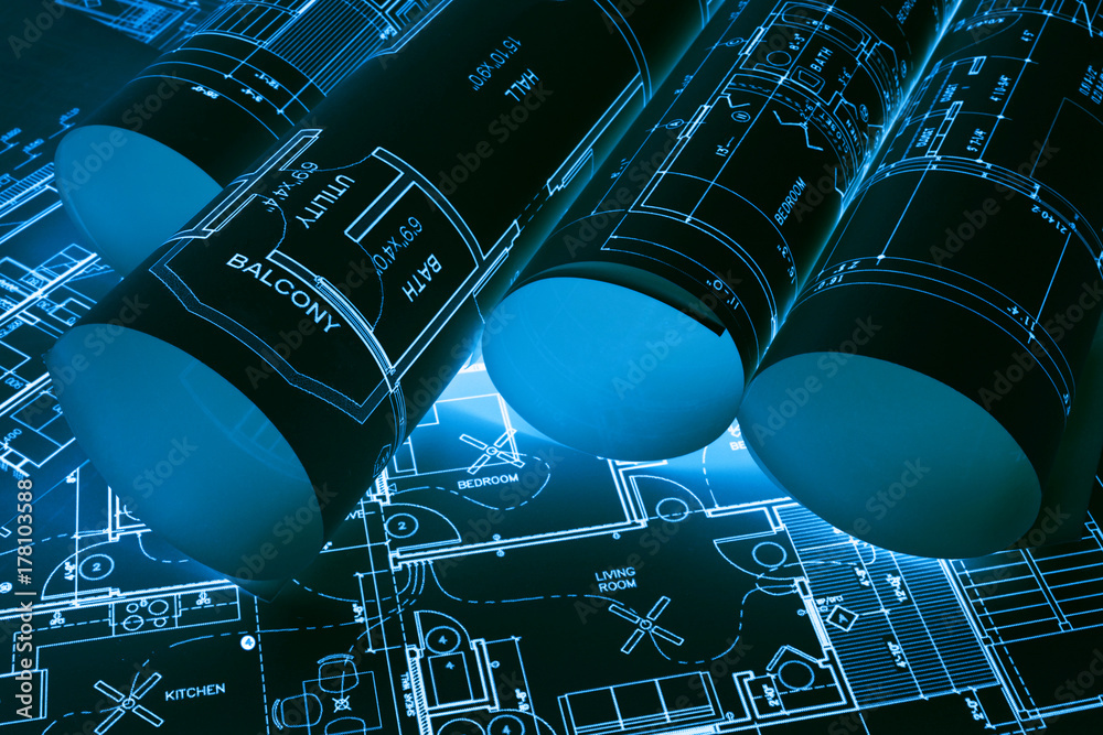 House blueprints, blue print style floor plans on architects desk ...